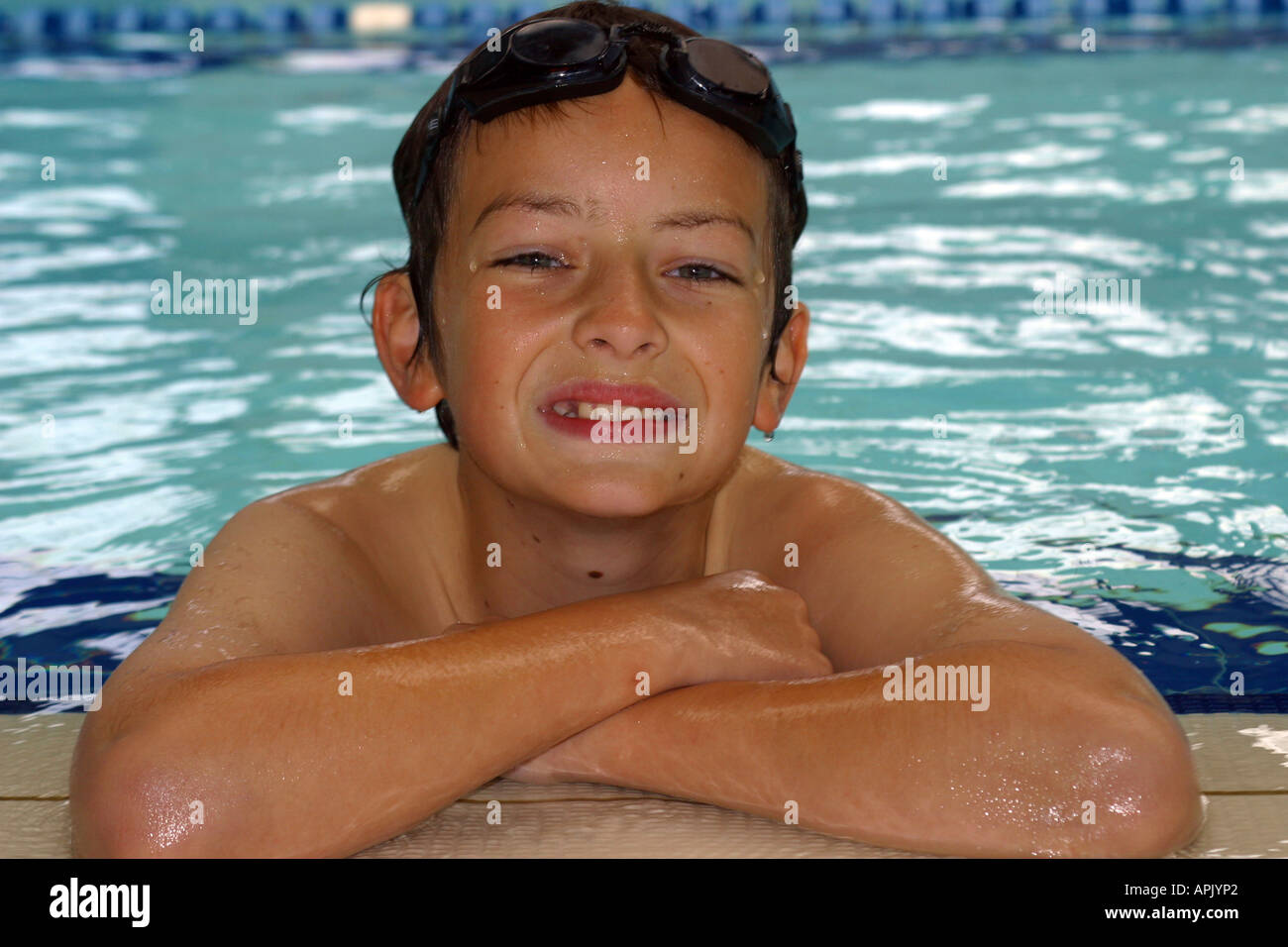 Young boy relaxing in a swimming pool Stock Photo - Alamy