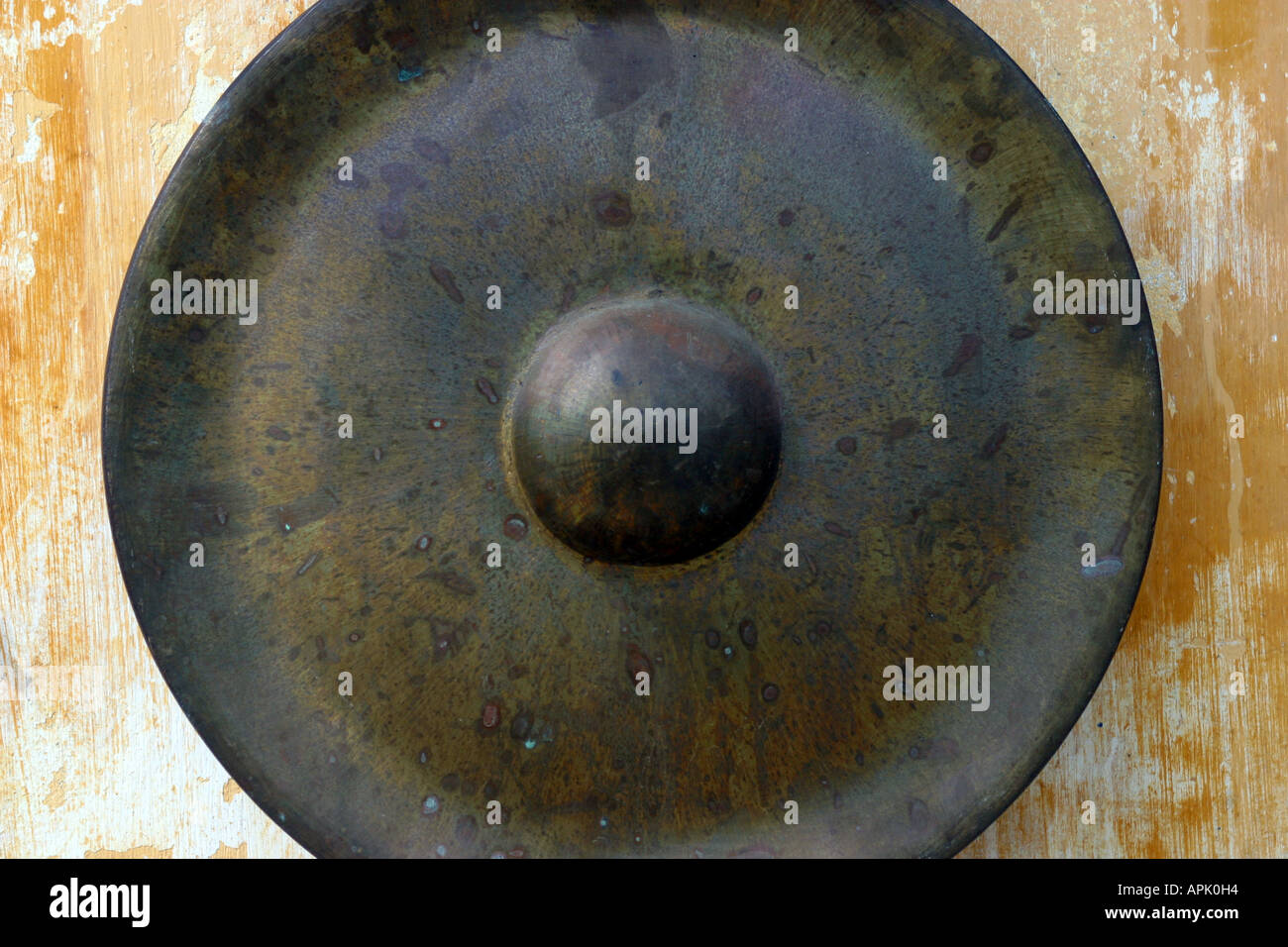 A metal disk gong with a turned rim giving a resonant note when struck ...