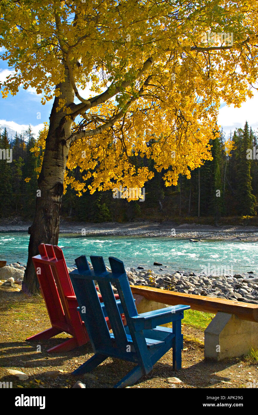 Two colorful empty wooden chairs on a river bank Stock Photo - Alamy