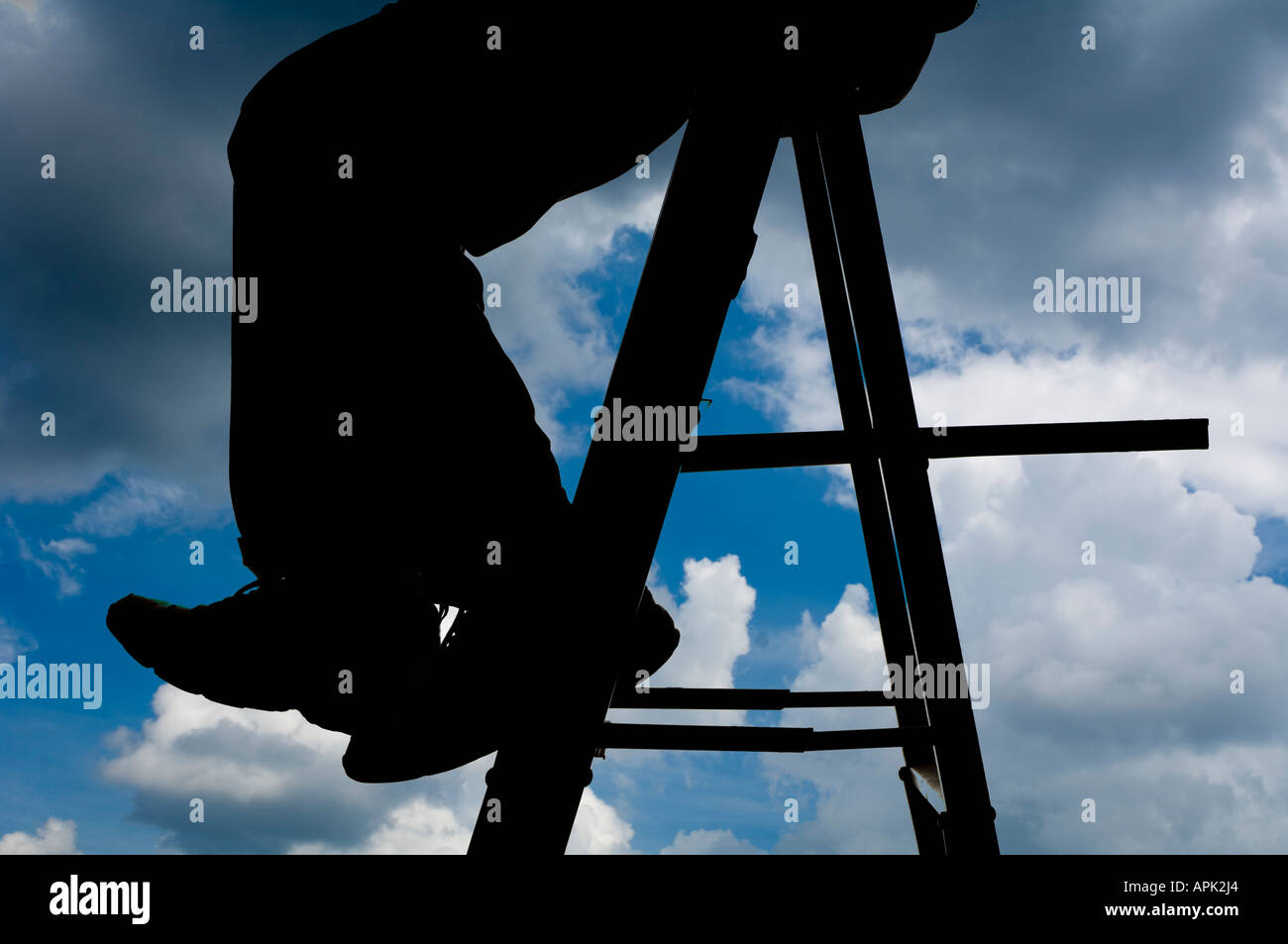 silhouette of man sitting on step ladder looking at clouds Stock Photo ...