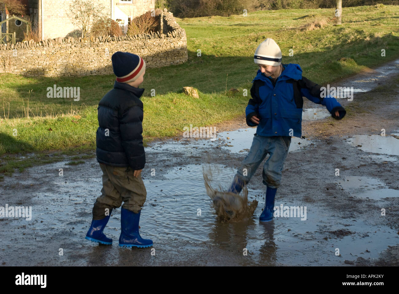 Boys playing in puddle Stock Photo - Alamy