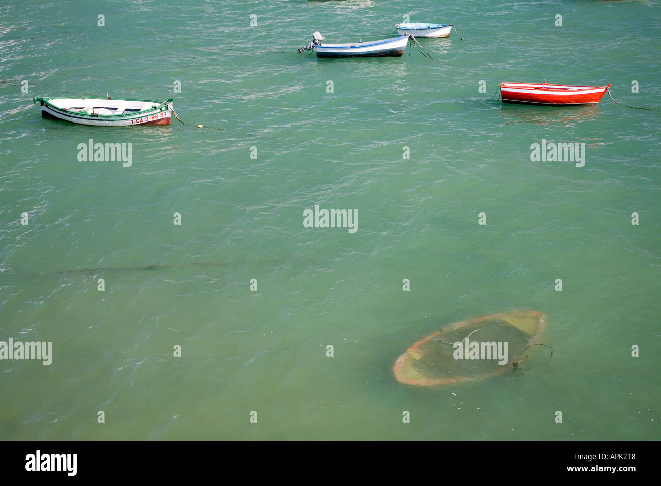 Colorful seafaring image of afloat and sunken boats Stock Photo - Alamy