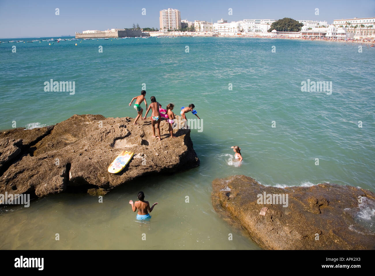 Young People Enjoying Sea at San Sebastian Castle Rocks, Cadiz, Spain ...