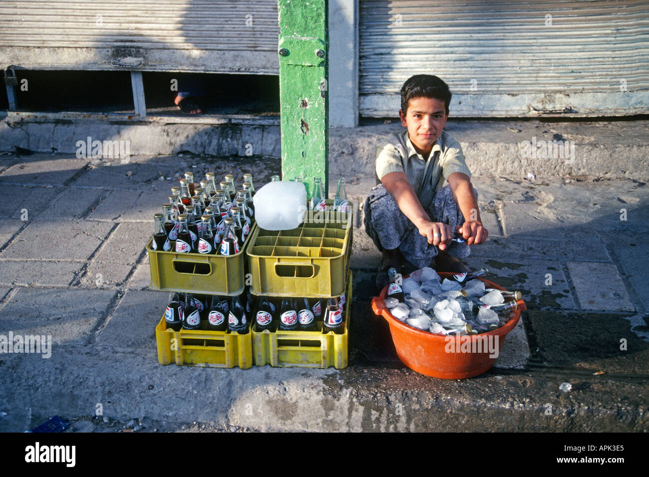 IRAQ BAGHDAD Young boy selling Pepsi on the street to help support his ...