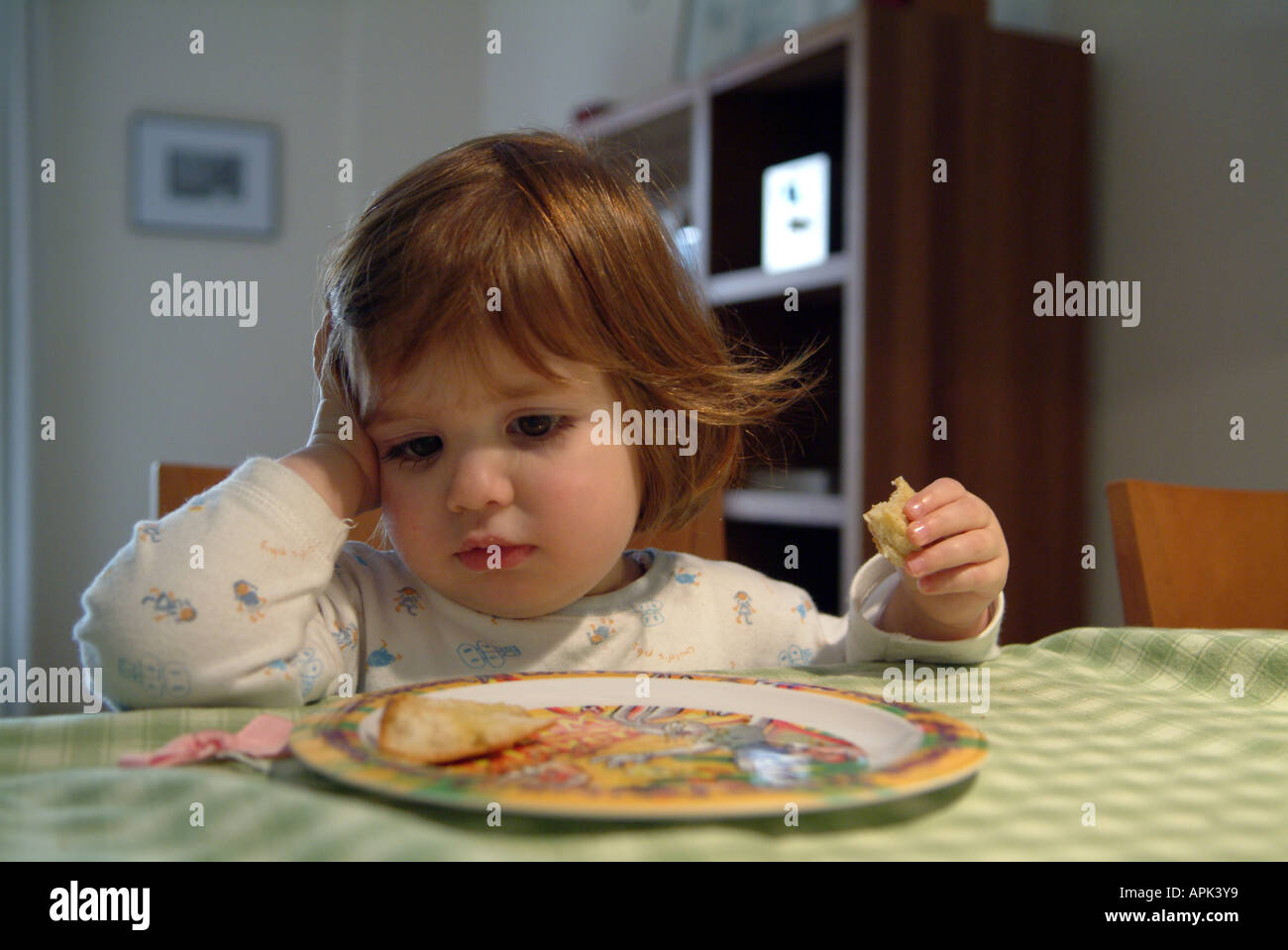 Sad little girl having her breakfast Stock Photo - Alamy
