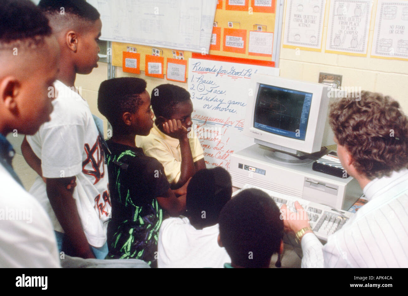 African American boys in remedial class watch as career counselor ...