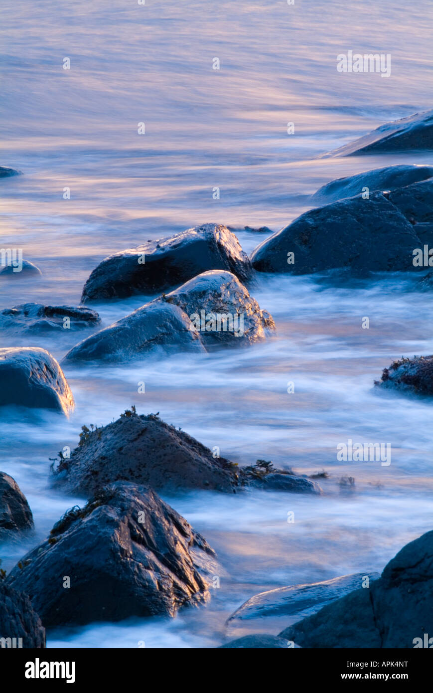 Rocks and surf at sunrise, Murlough Bay County Antrim Northern Ireland ...
