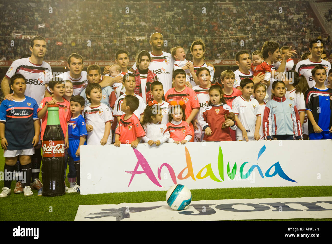 Sevilla FC squad posing with infant fans before the match Stock Photo ...