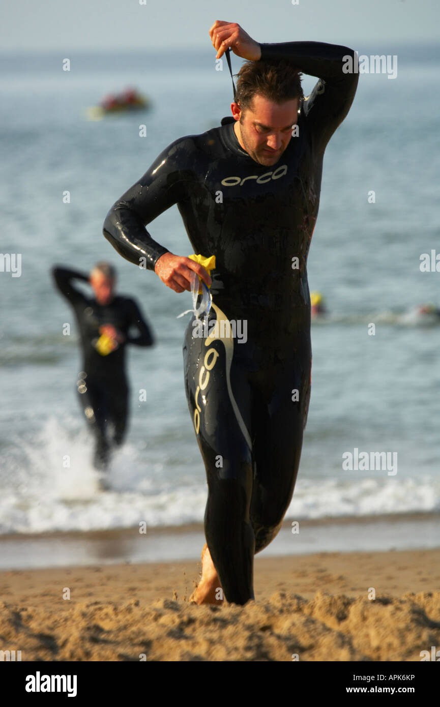 Triathletes emerging from sea swim Stock Photo - Alamy