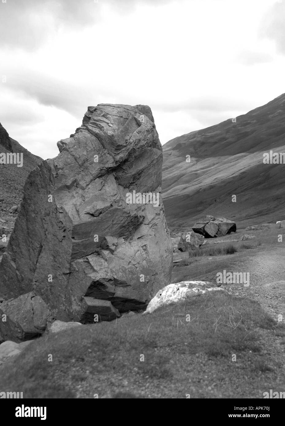 A large fallen rock by the side of a road Stock Photo - Alamy