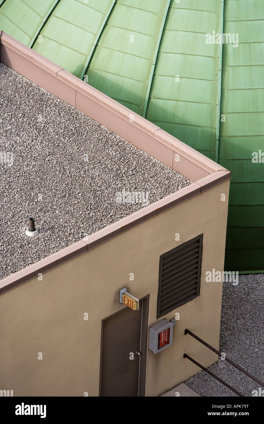 A building's rooftop emergency fire escape beside a green oxidized dome ...