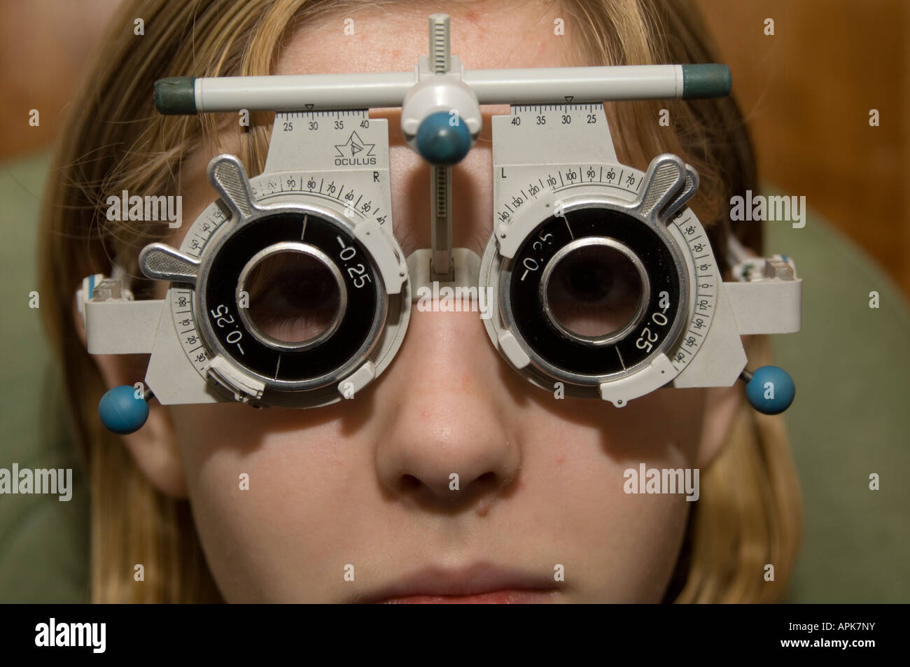 Teenage girl having her eyes tested by an optician Stock Photo - Alamy