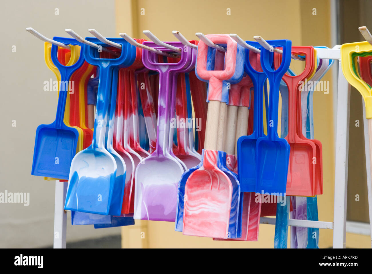 Plastic toy spades hanging outside a seaside shop Stock Photo - Alamy