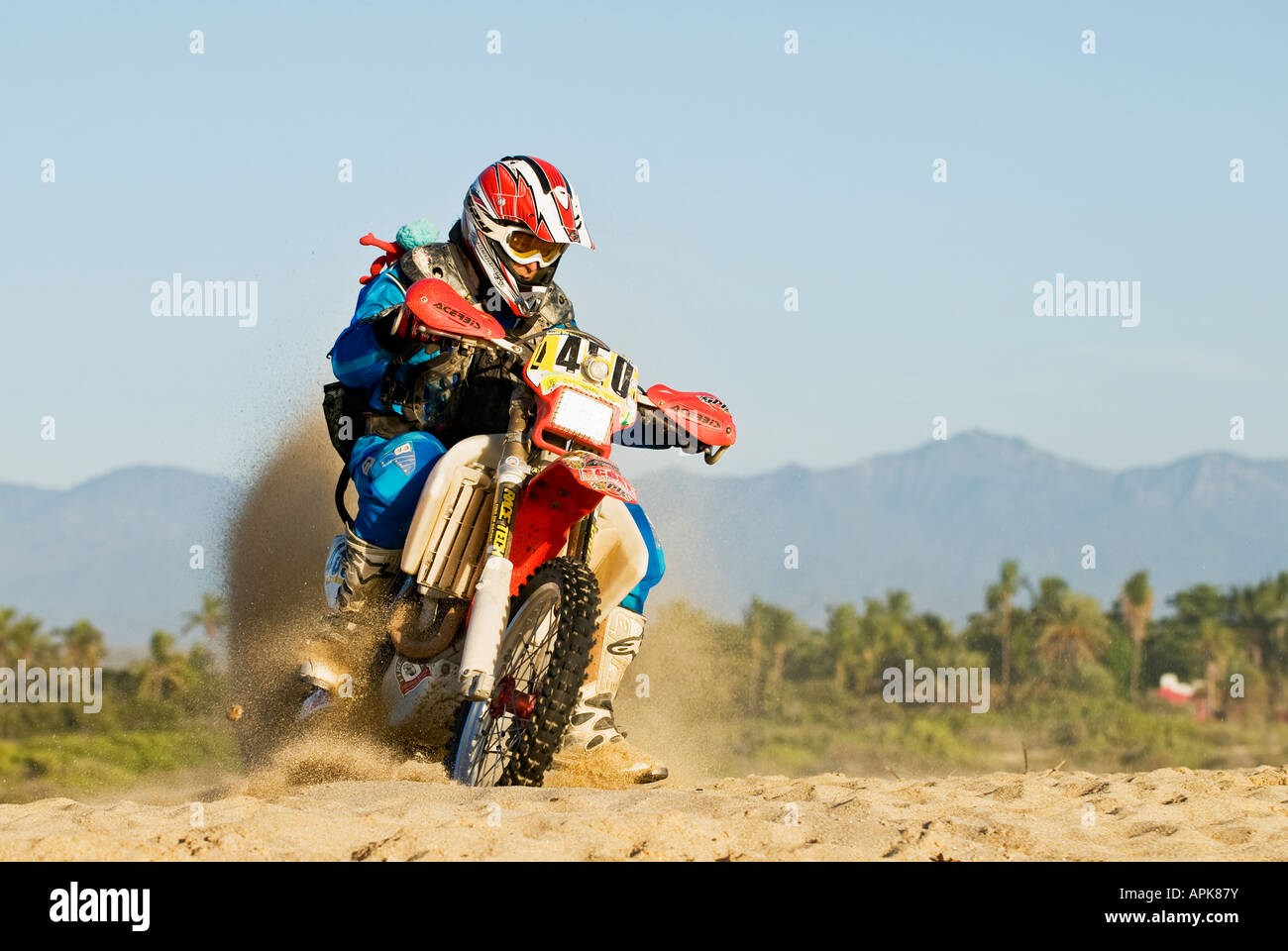 Male motorcycle rider riding on sandy beach in Baja California, Mexico ...