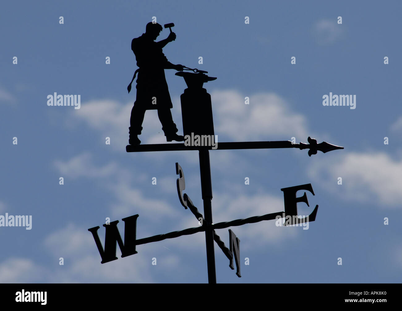 Wrought iron weather vane in the form of a blacksmith hammering on an ...