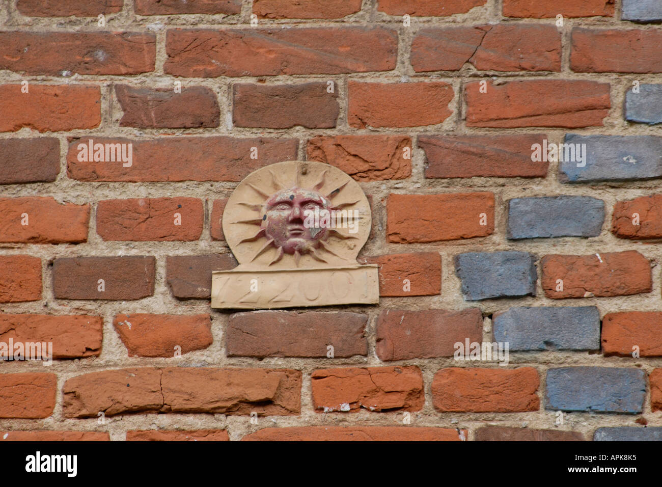 Metal sun sign with a number perhaps an old insurance company symbol on ...