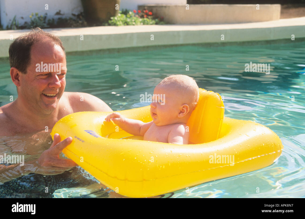 Boy on inflatable in pool hi-res stock photography and images - Alamy