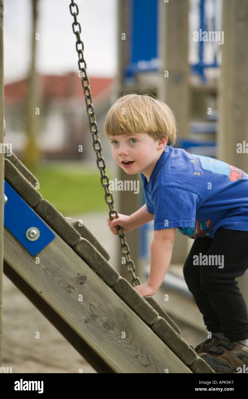 3 Year Old Boy Climbing up a Playground Gym Stock Photo - Alamy
