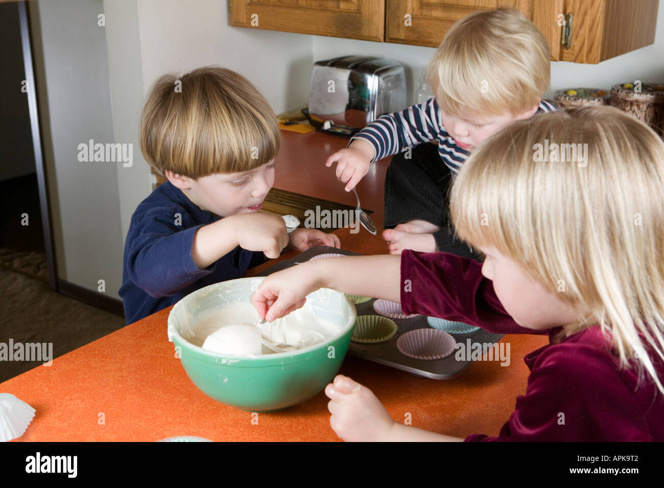 Helping to Make Cup Cakes Stock Photo - Alamy