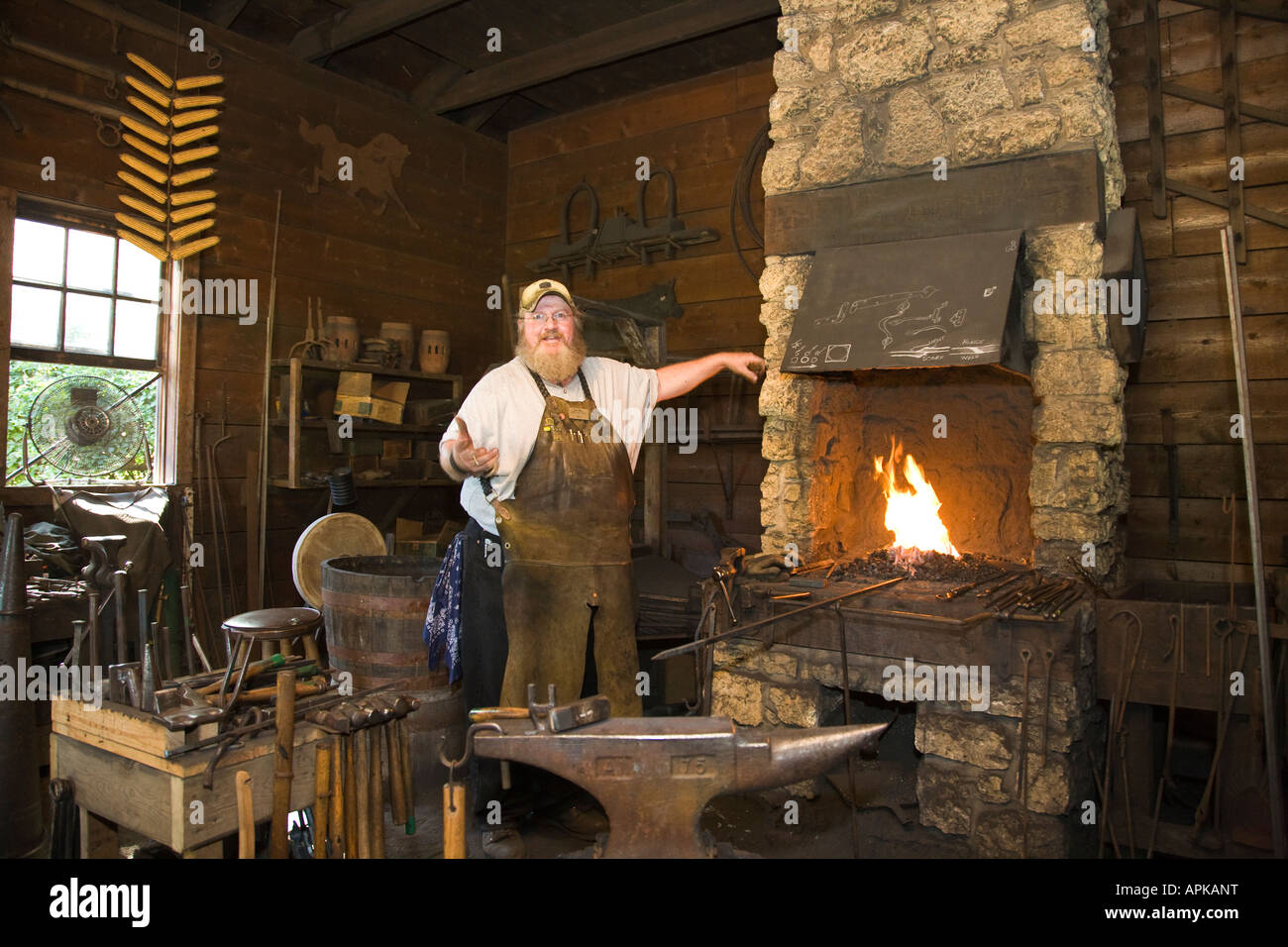 ILLINOIS Grand Detour Blacksmit standing by forge blacksmith shop at ...
