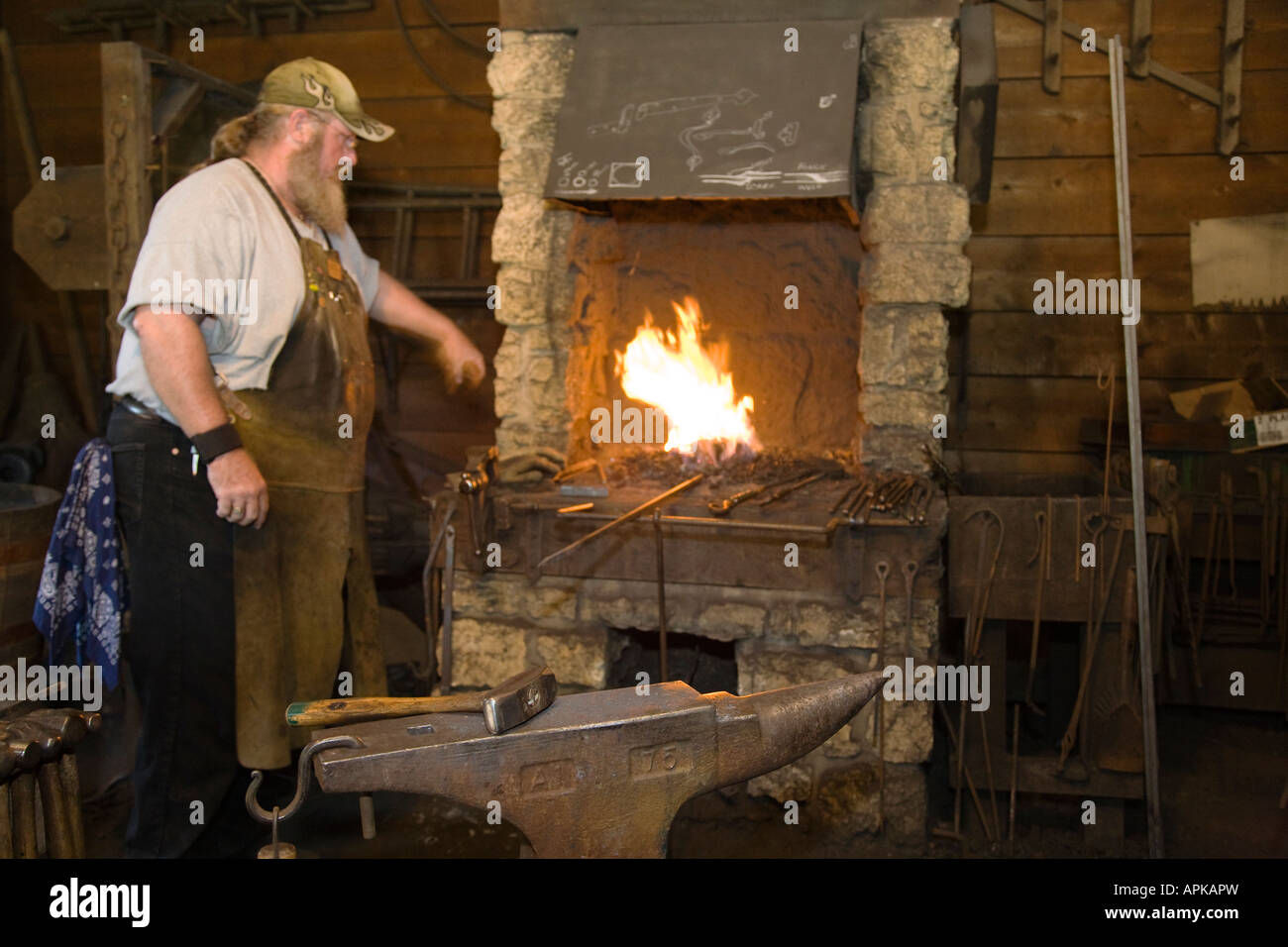 ILLINOIS Grand Detour Blacksmith standing by forge blacksmith shop at ...