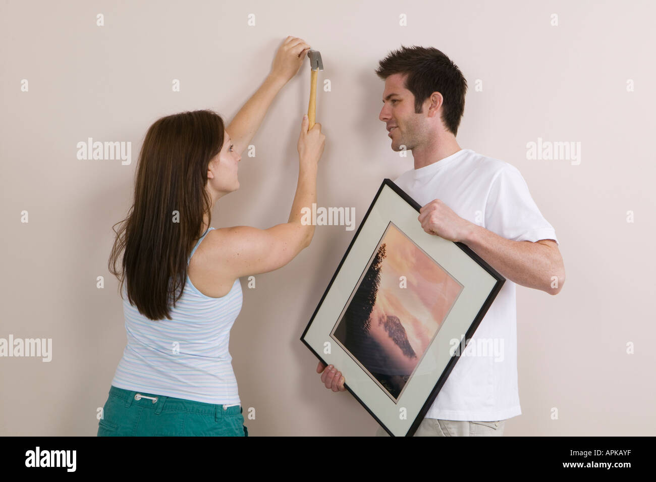 Couple Hanging a Picture Stock Photo - Alamy