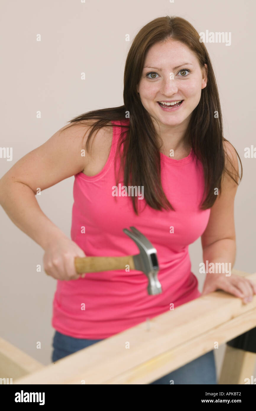 Woman hammering a nail hi-res stock photography and images - Alamy