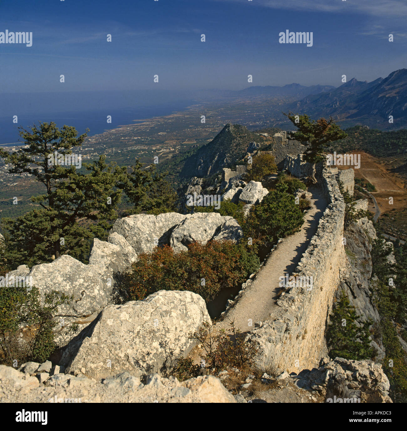 Looking along top of ruins of old castle walls down over Girne and ...