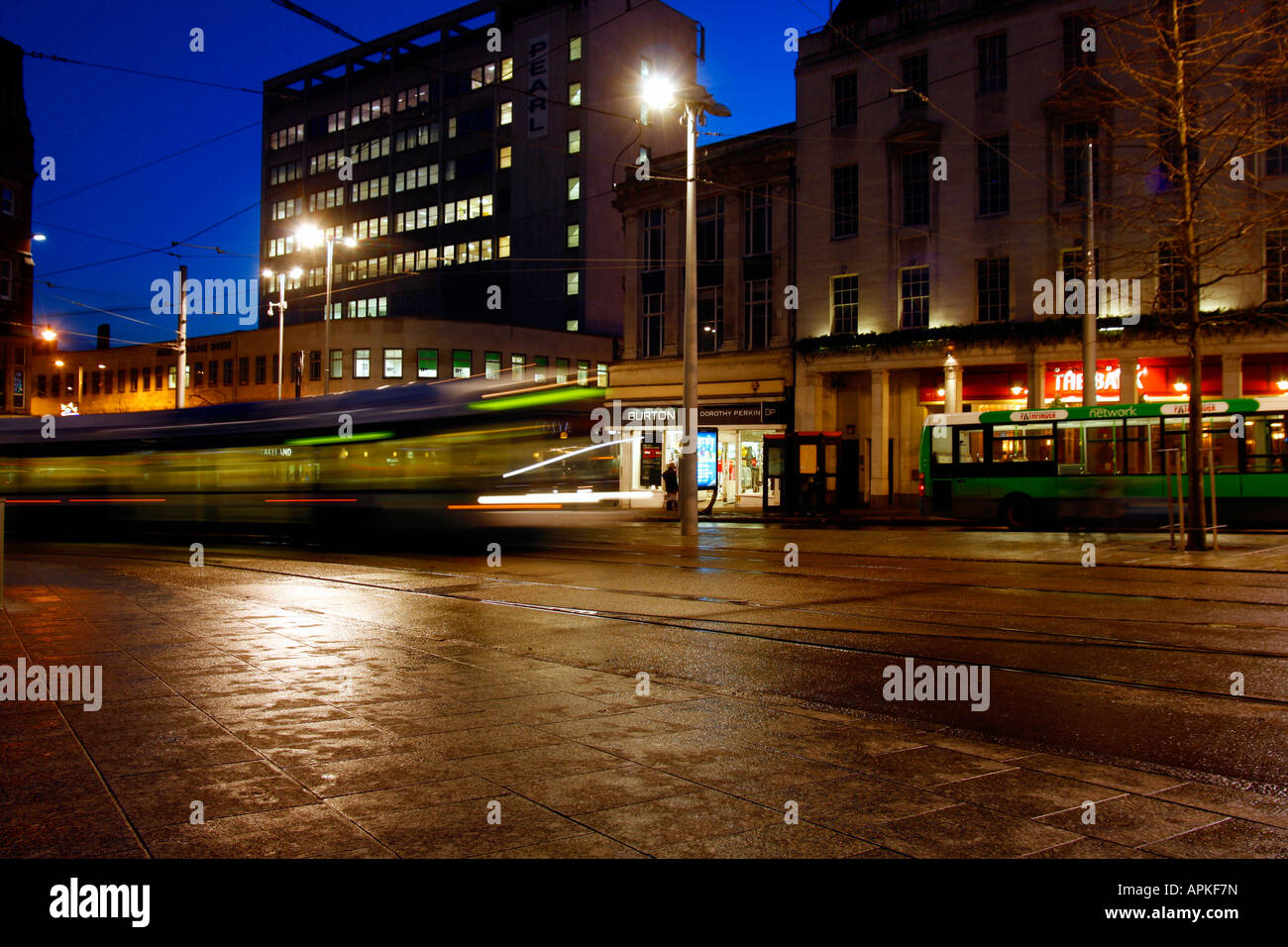 The blur of a Nottingham tram at Night-time in Nottinghams Market ...