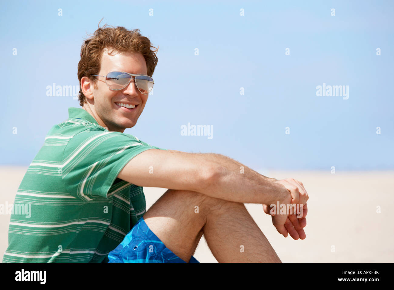 Young man smiling at beach Stock Photo - Alamy