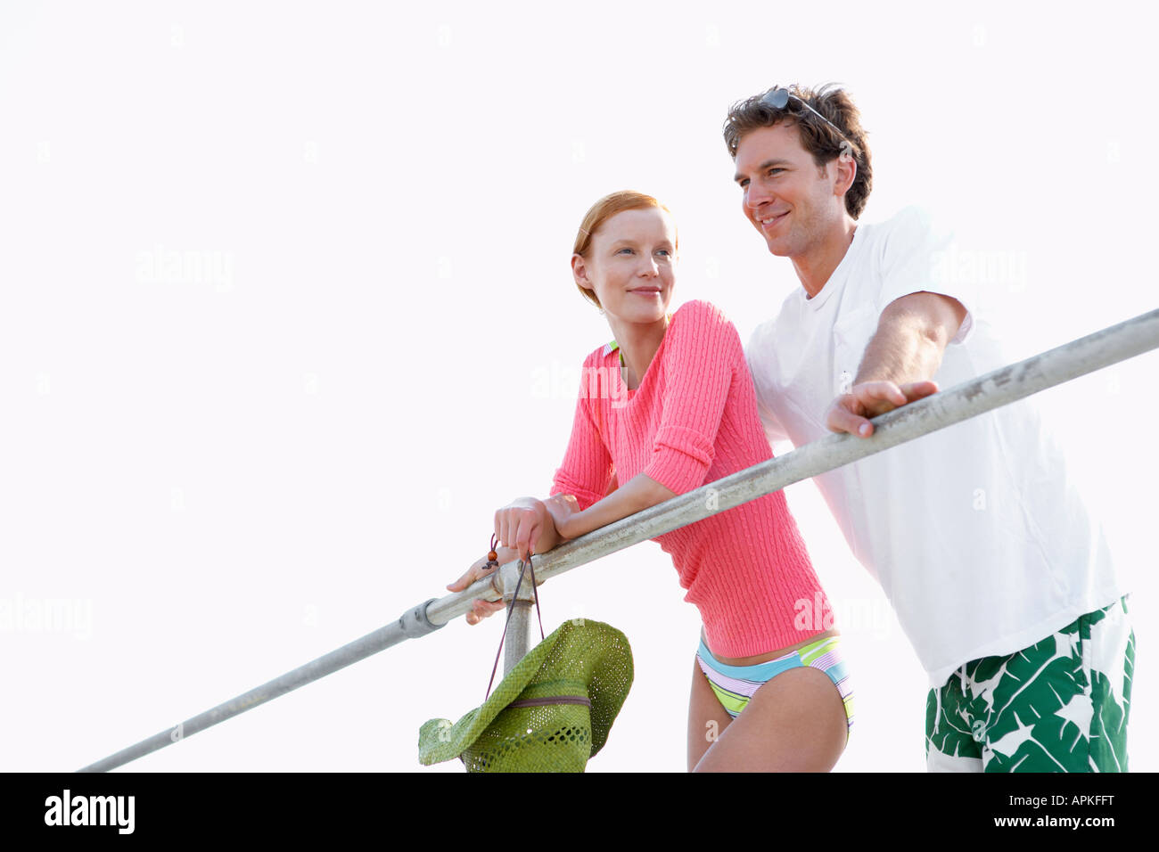 Young couple leaning against railings (low angle view Stock Photo - Alamy