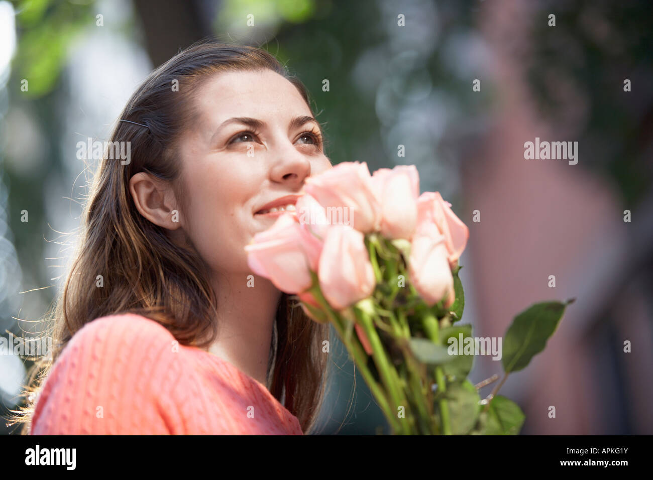 Young woman smelling roses hi-res stock photography and images - Alamy