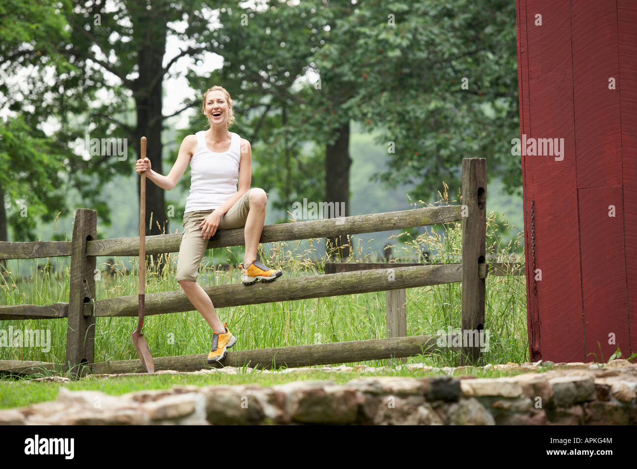 Gardener sitting on wooden fence Stock Photo - Alamy
