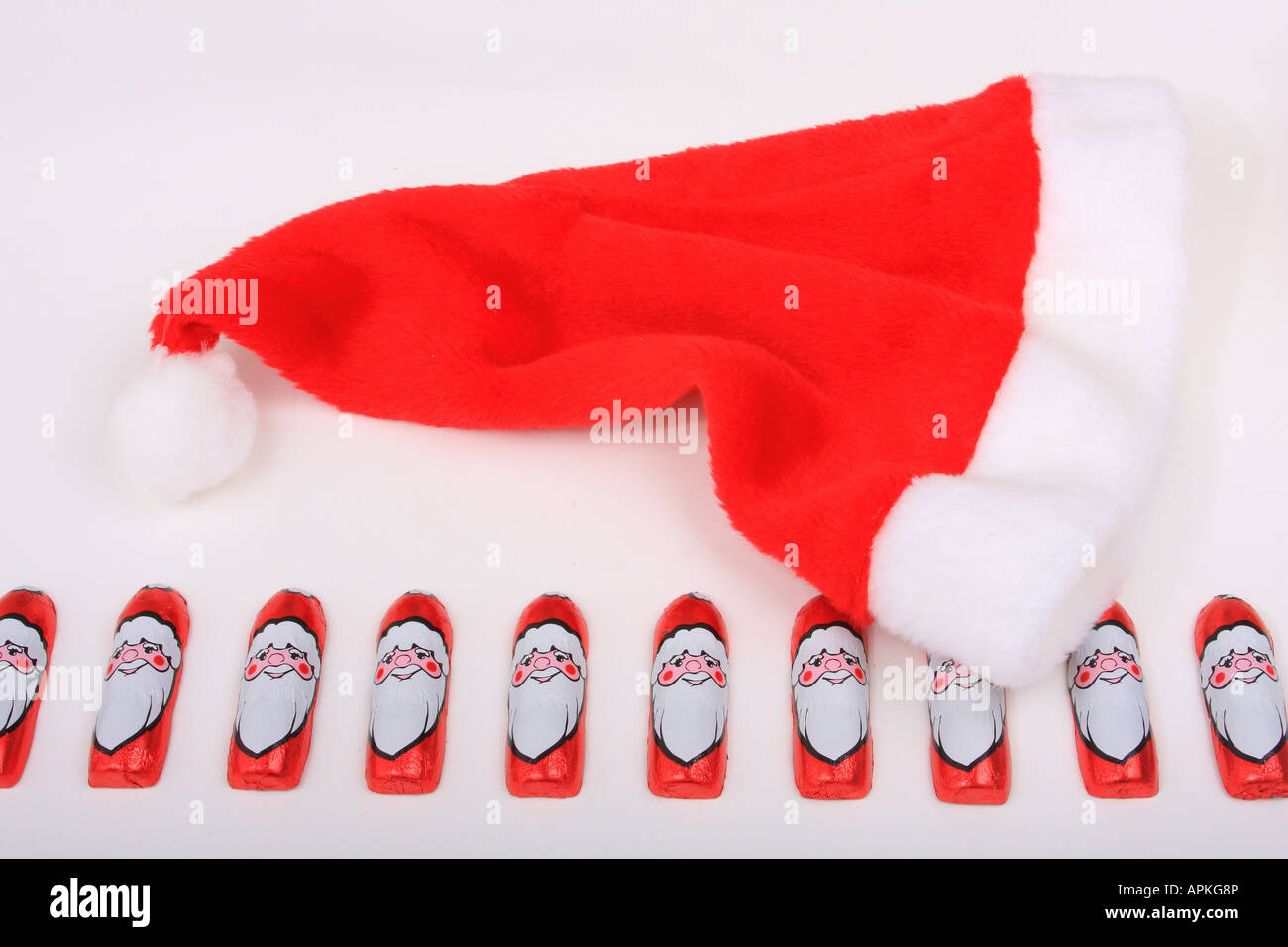chocolate santa clauses in rank with santa claus cap Stock Photo - Alamy