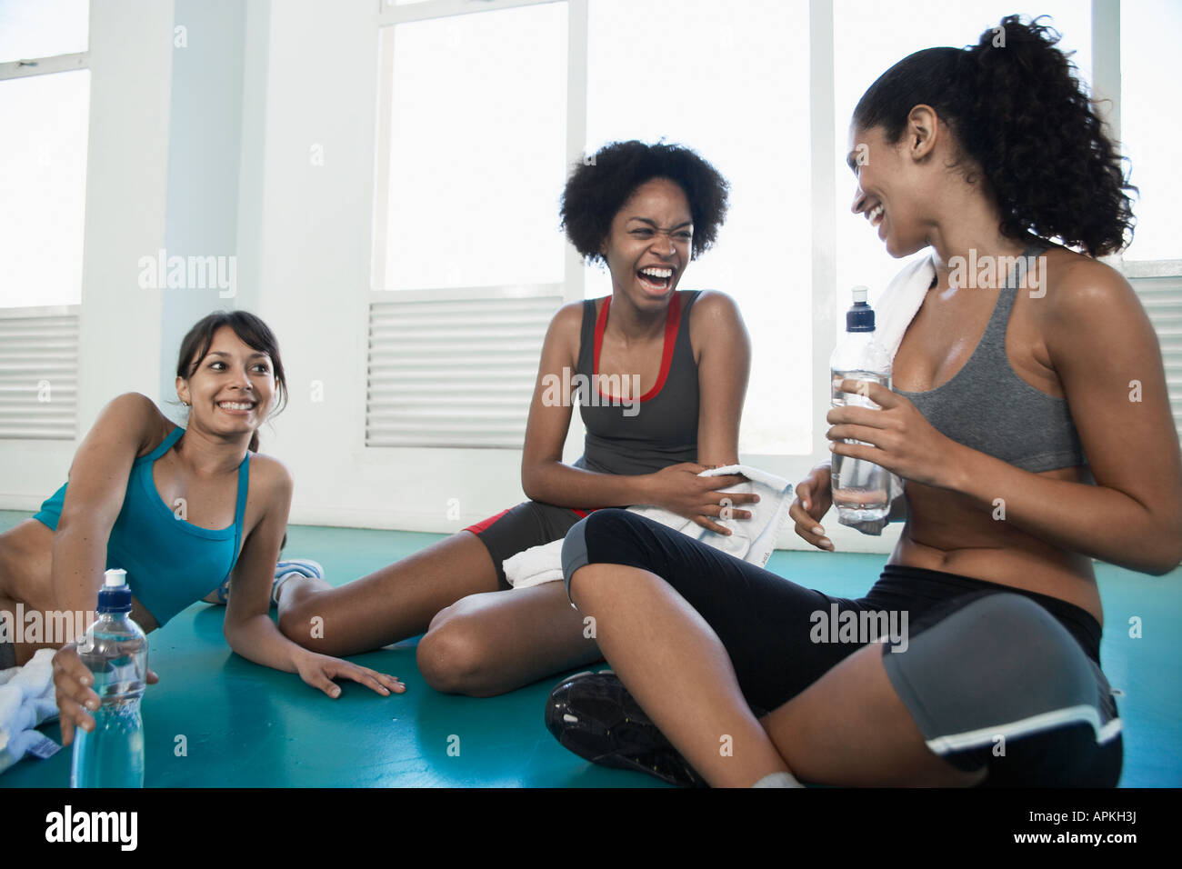 Young women in sports clothing talking Stock Photo - Alamy