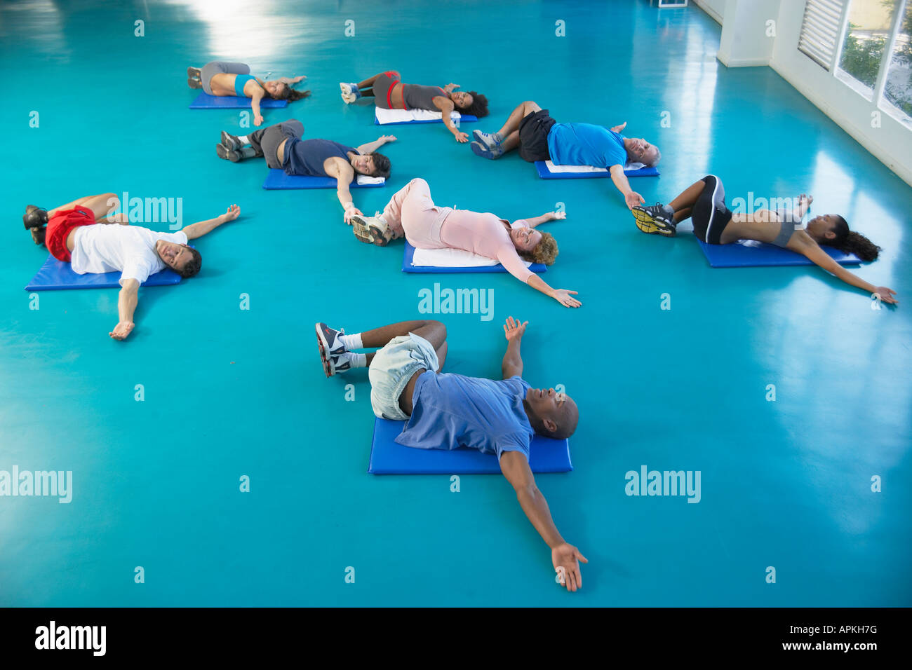 Group stretching on floor (high angle view Stock Photo - Alamy