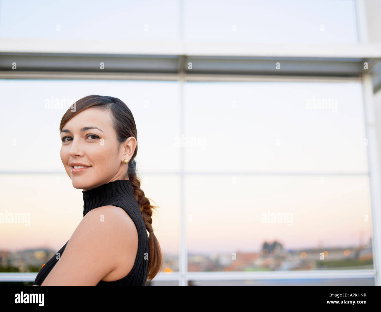Young woman against windows (portrait Stock Photo - Alamy