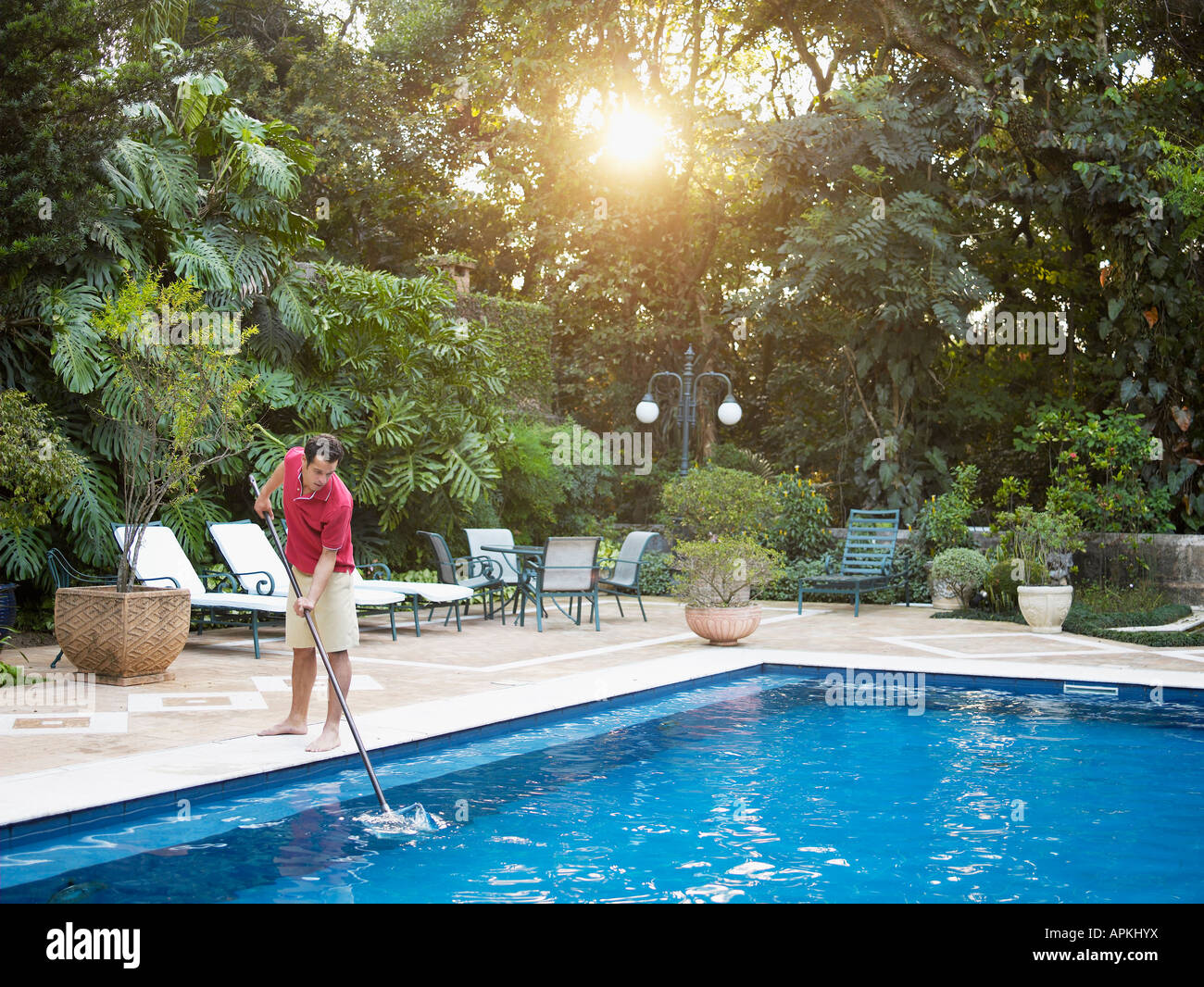 Man cleaning swimming pool Stock Photo - Alamy