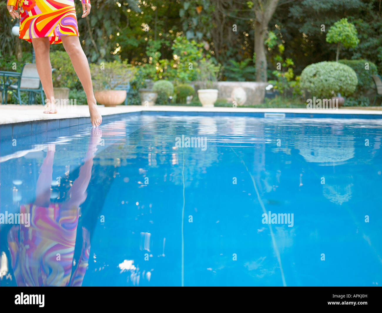 Woman dipping toe in swimming pool (close-up, low angle view Stock ...