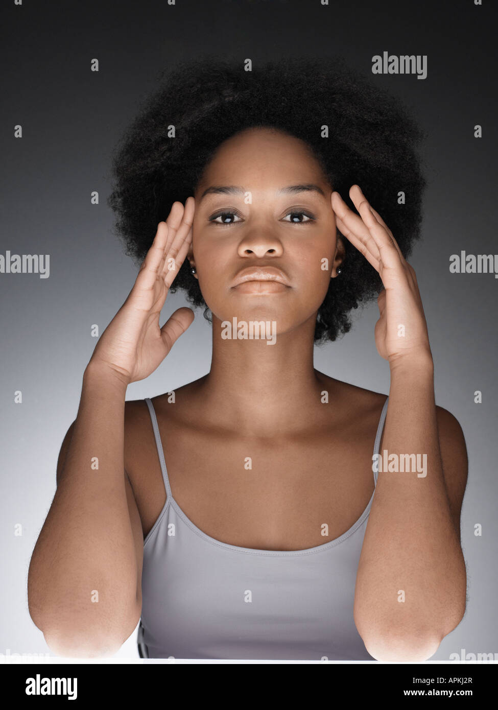 Young woman thinking with hands on face Stock Photo - Alamy