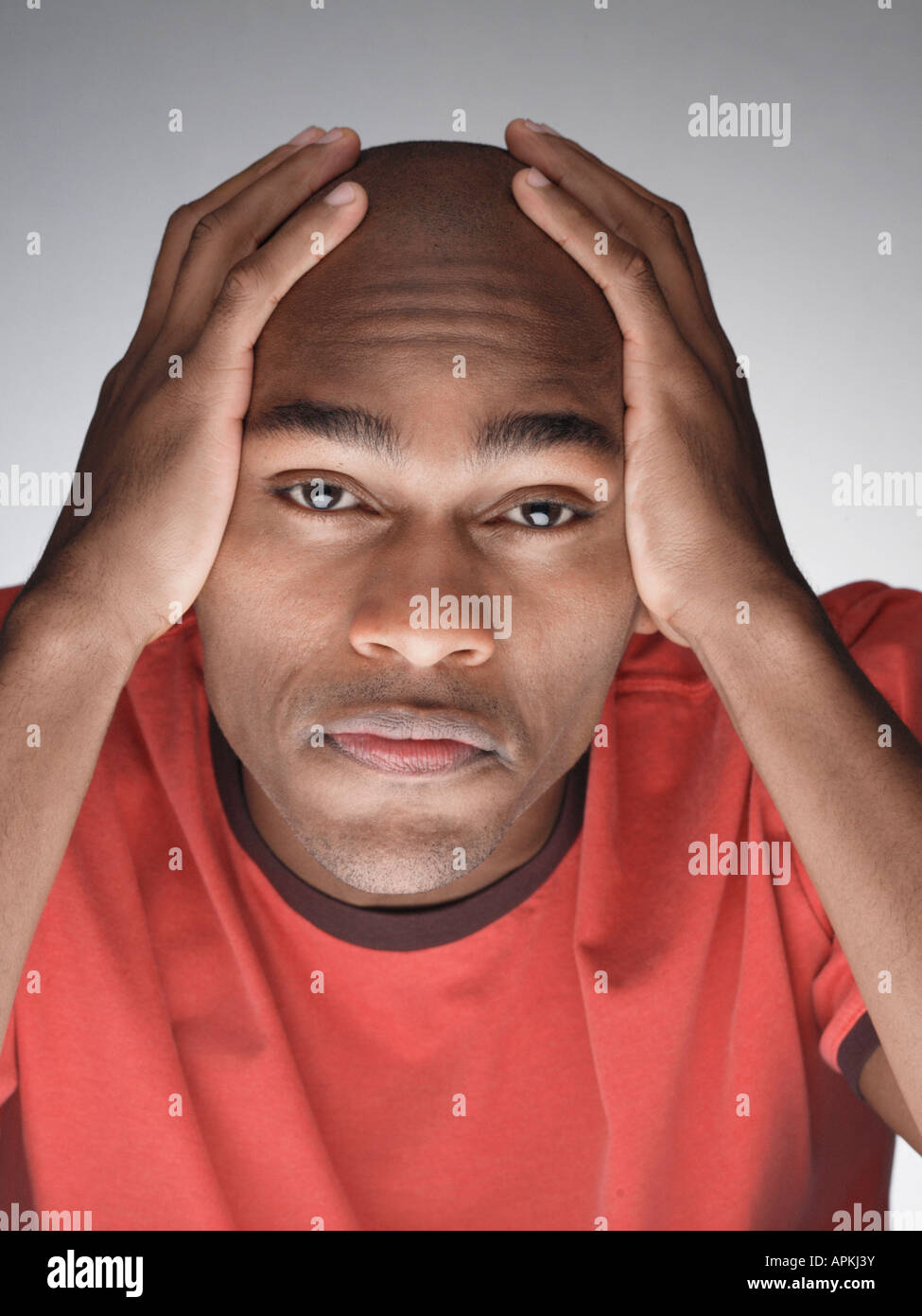 Young man with hands on head (portrait Stock Photo - Alamy