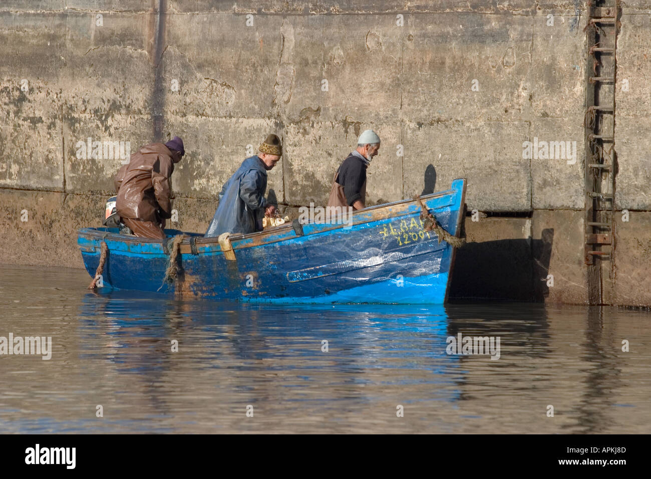 three fishermen returning to harbour Stock Photo - Alamy