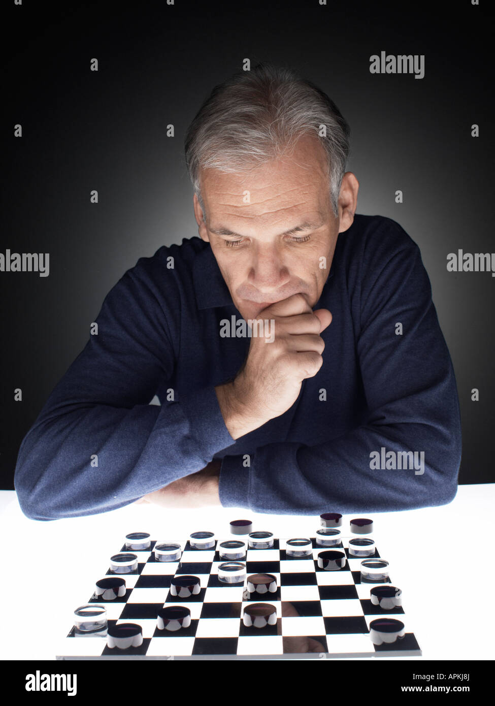 Man playing checkers Stock Photo - Alamy