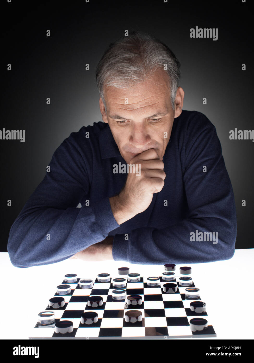 Man playing checkers Stock Photo - Alamy