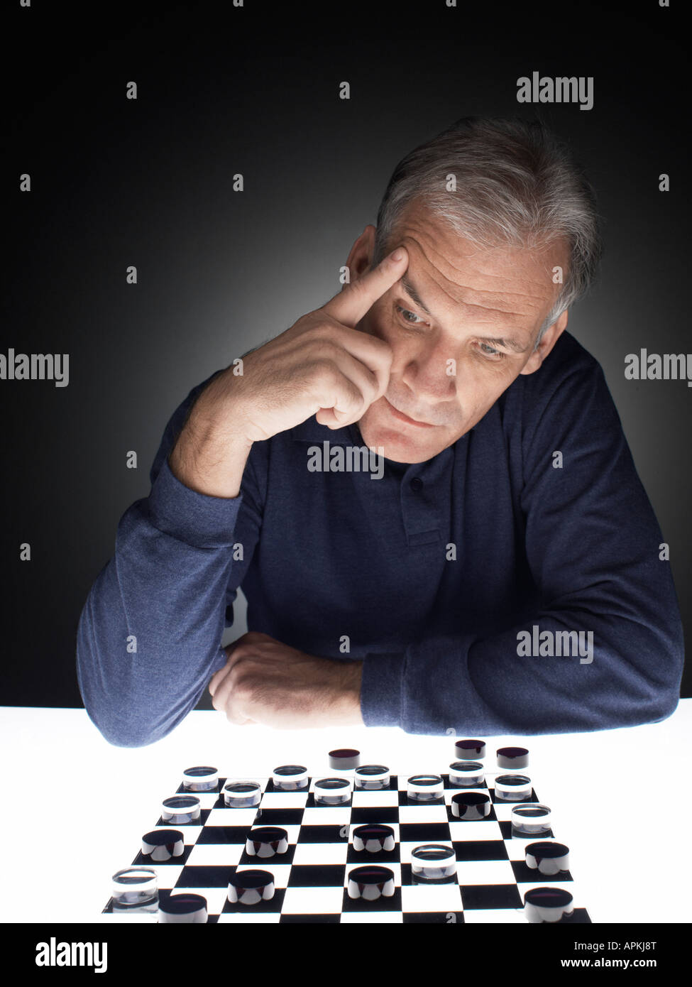 Man playing checkers Stock Photo - Alamy