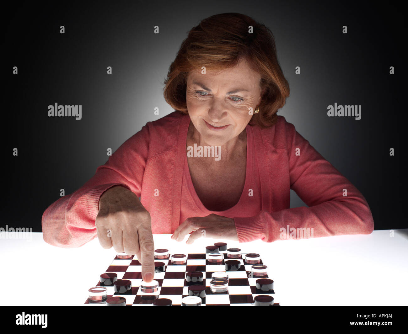 Woman playing checkers Stock Photo - Alamy