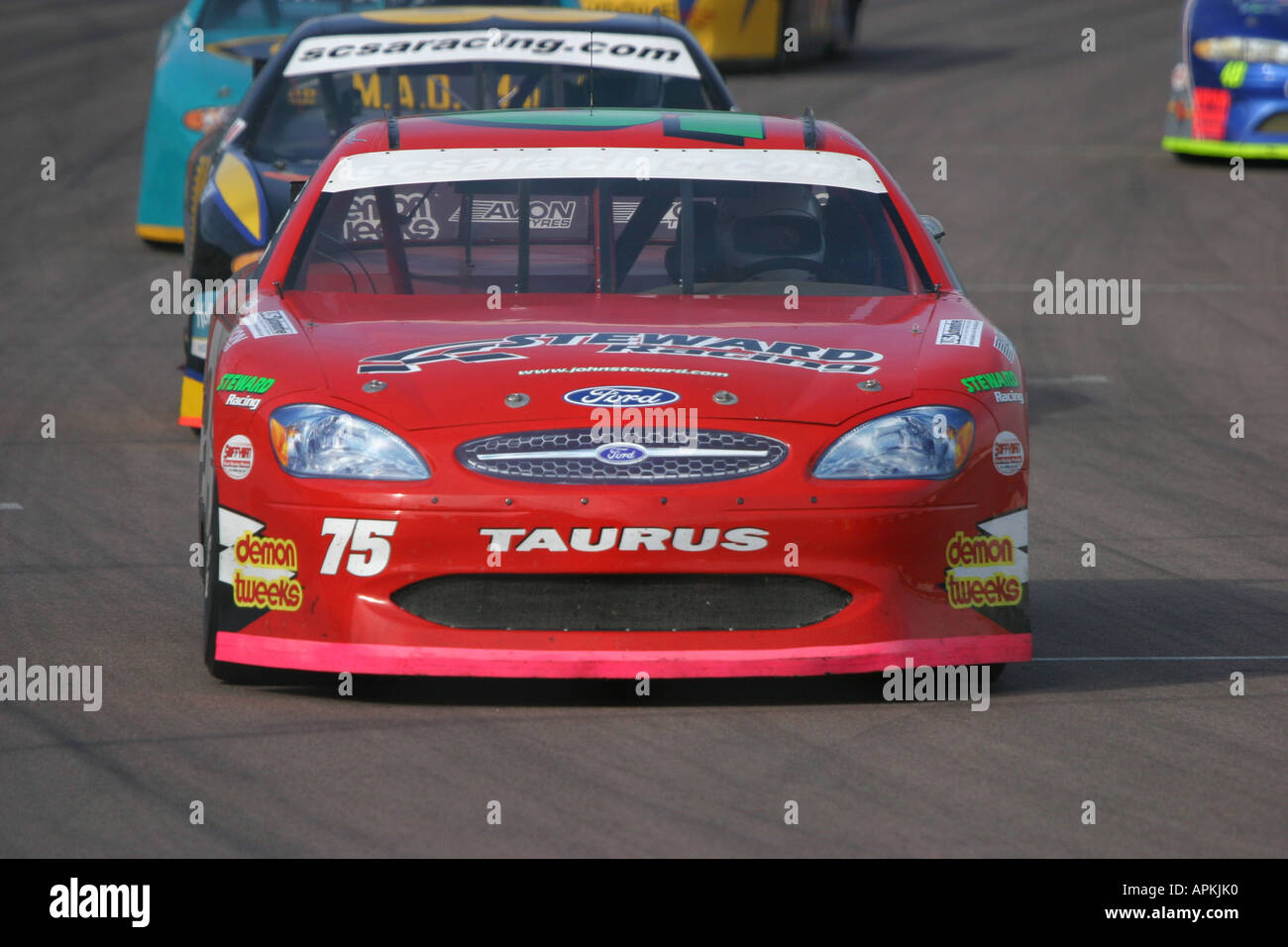 V8 Nascar type stock cars racing on a banked oval circuit Stock Photo ...