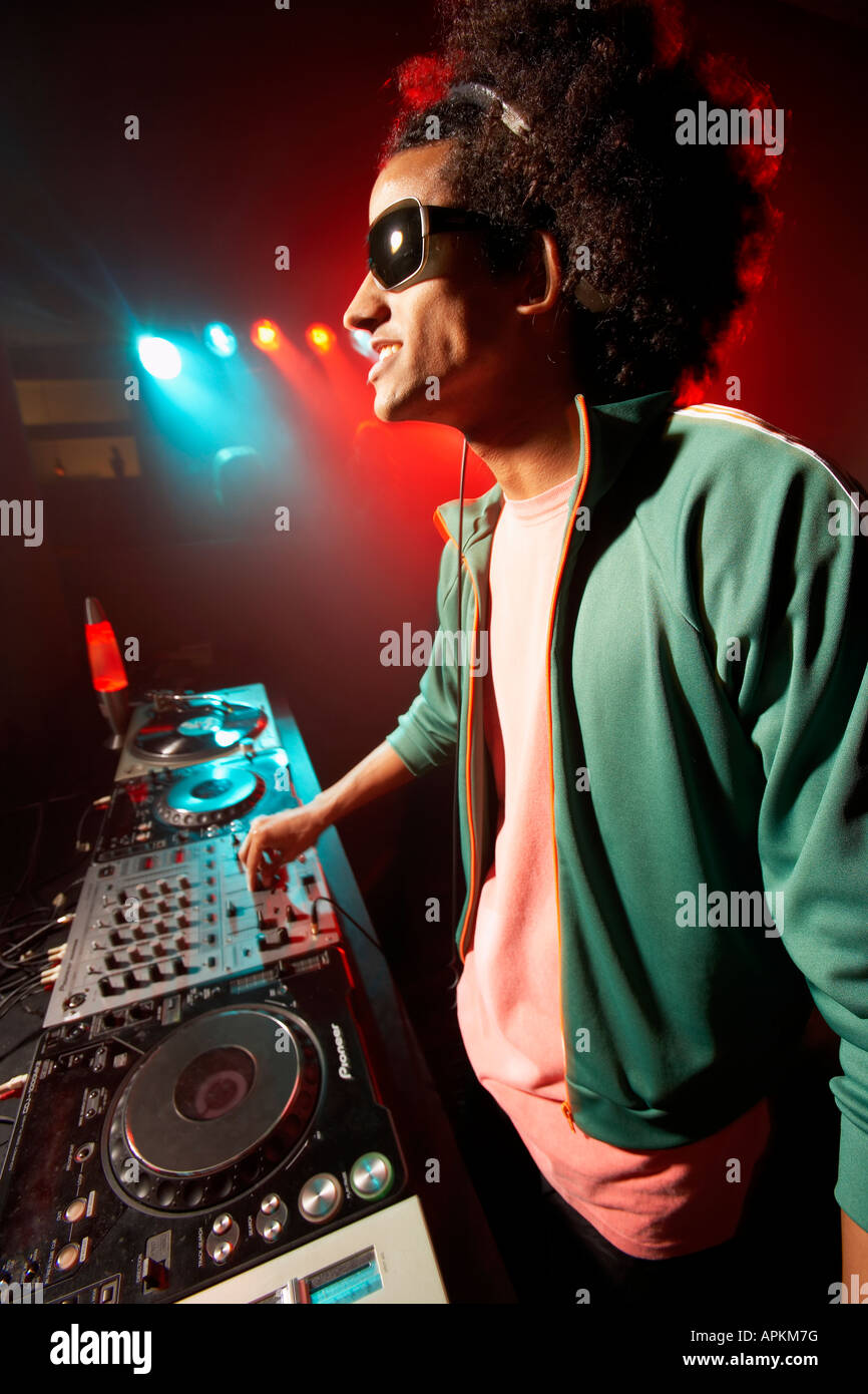 Disk jockey playing records at nightclub Stock Photo - Alamy