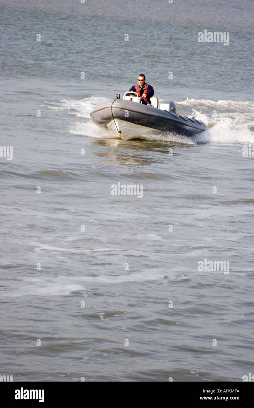 colour image off a speed boat speeding along in the sea lots off waves ...