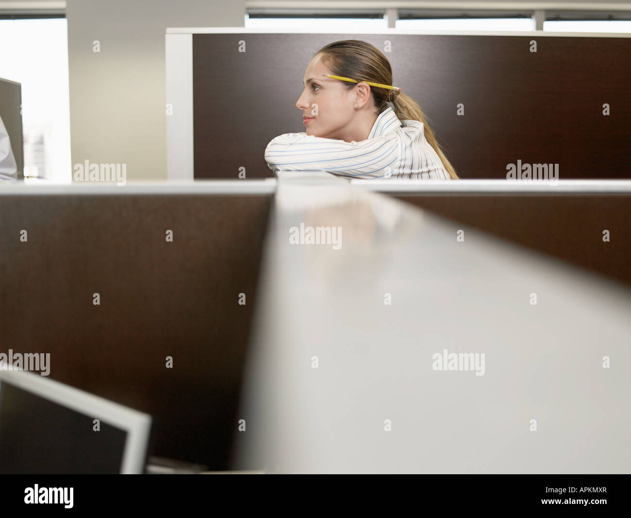 Office worker leaning against partition wall Stock Photo - Alamy